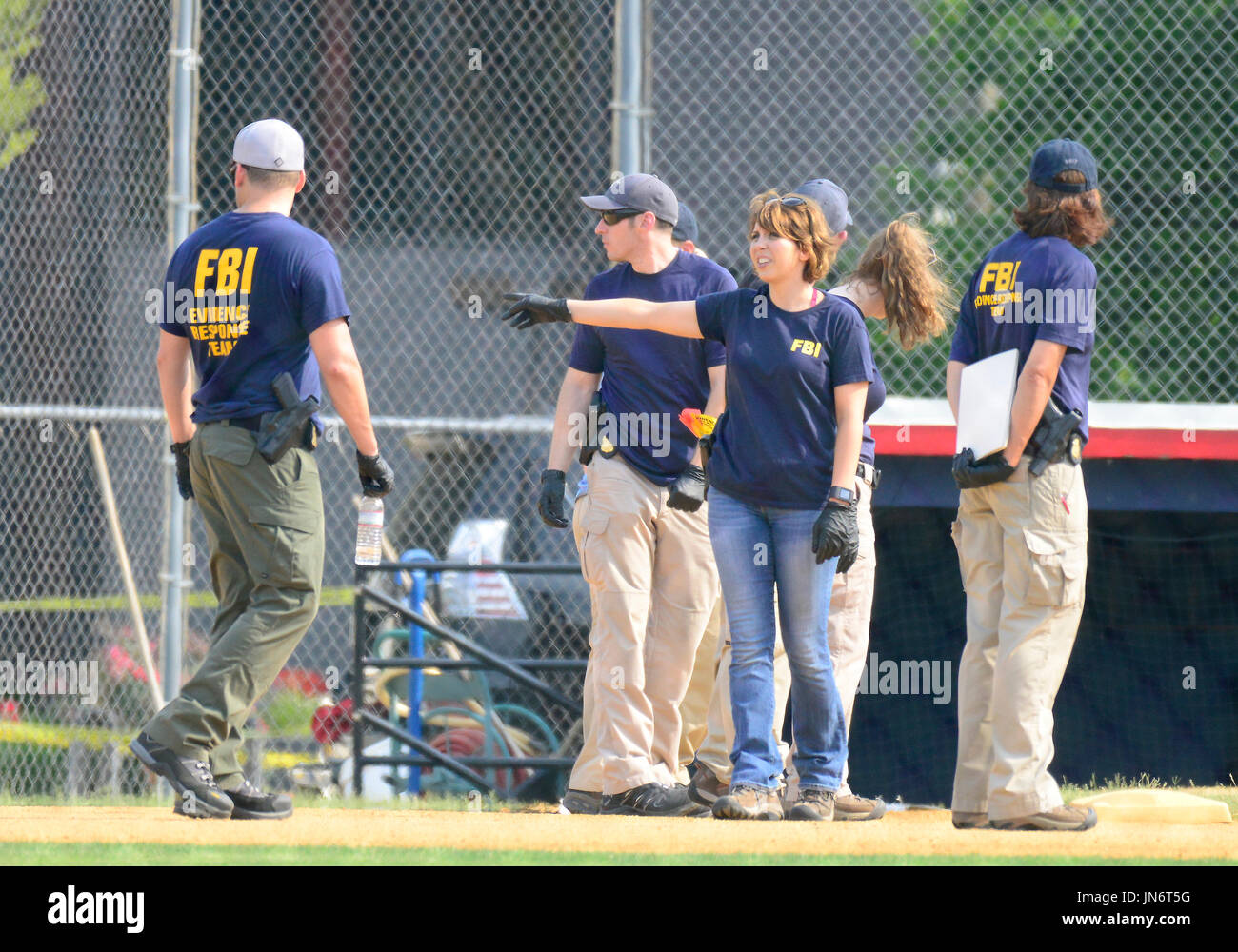 Evidence technicians from the FBI comb through the crime scene for ...