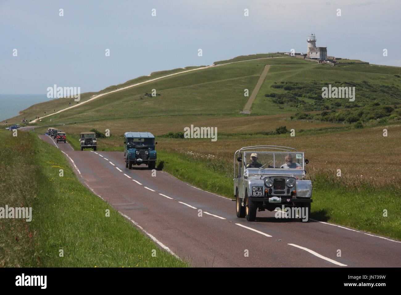 A SUNNY LANDSCAPE VIEW OF A GROUP OF LAND ROVER SERIES 1 ON A CLASSIC ...