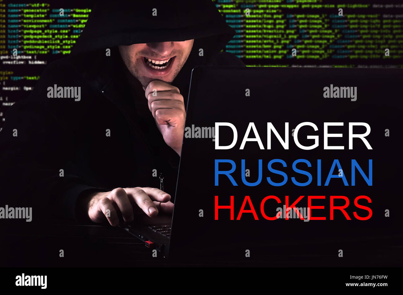 the concept of risk Russian hackers. Joyful Russian hacker sitting at a ...