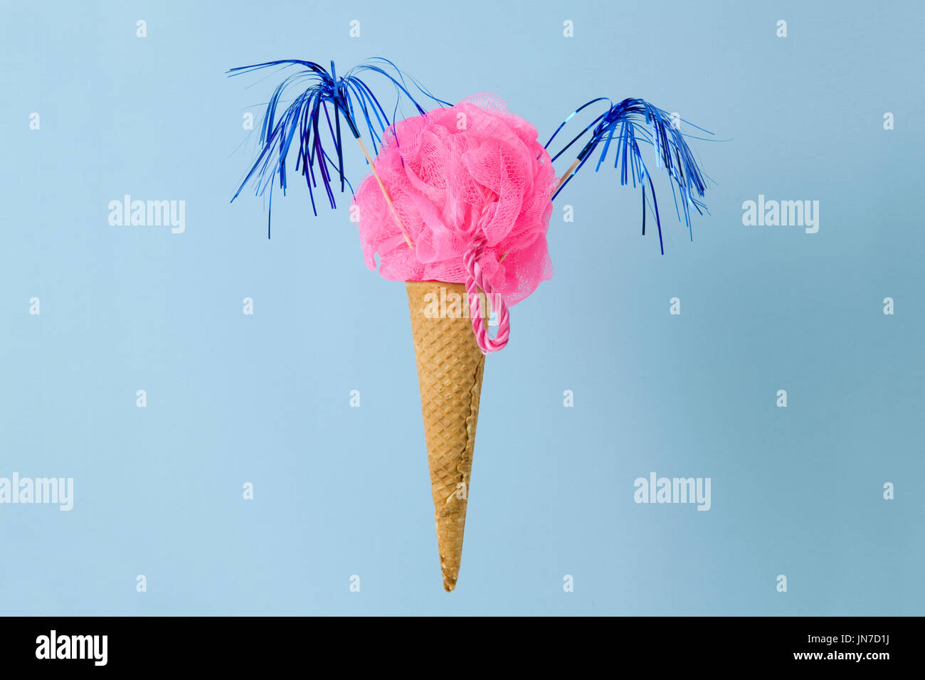 An ice cream cone whose scoop is replaced by a pink plastic loofah ...