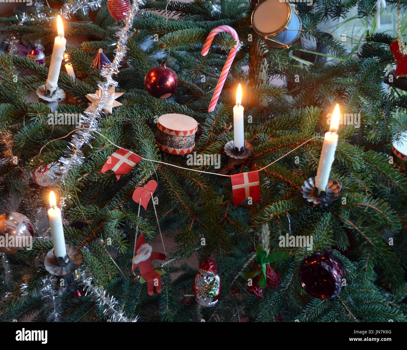 Decorated christmas tree with live candles and parcels underneath Stock ...