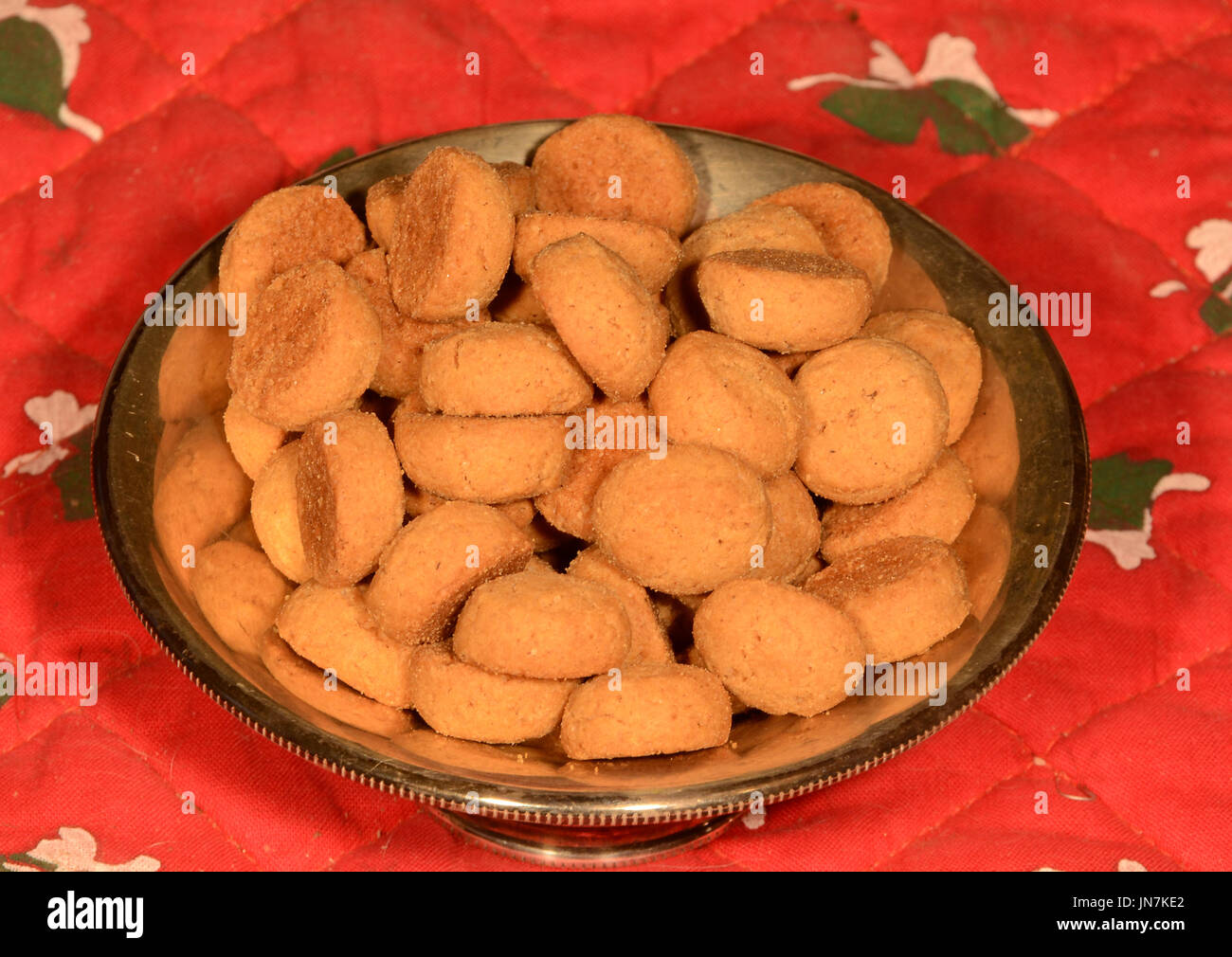 Small ball shaped cakes baked at Christmas in a shale on a red pad ...