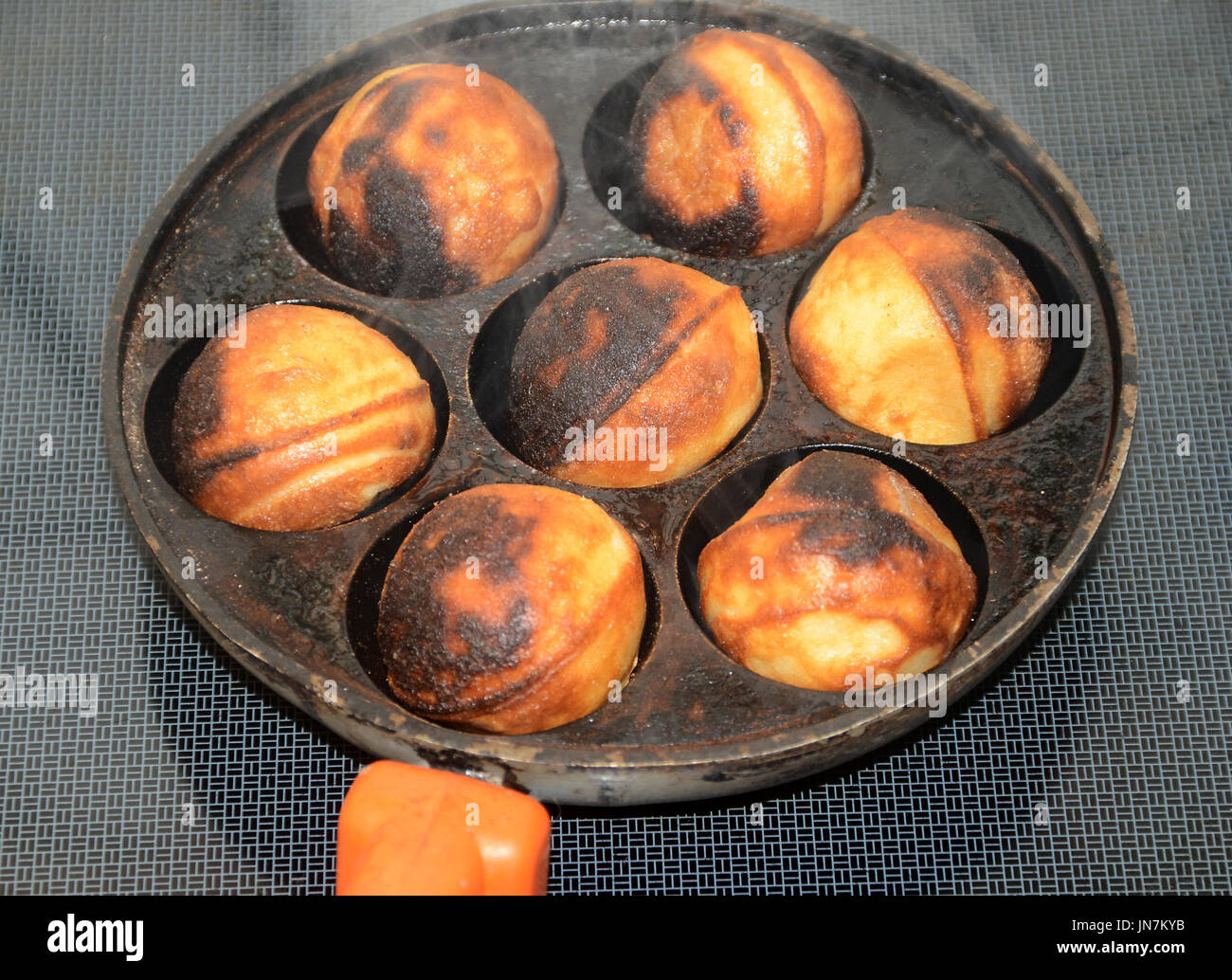 Christmas doughnuts cooking on a special pan Stock Photo - Alamy