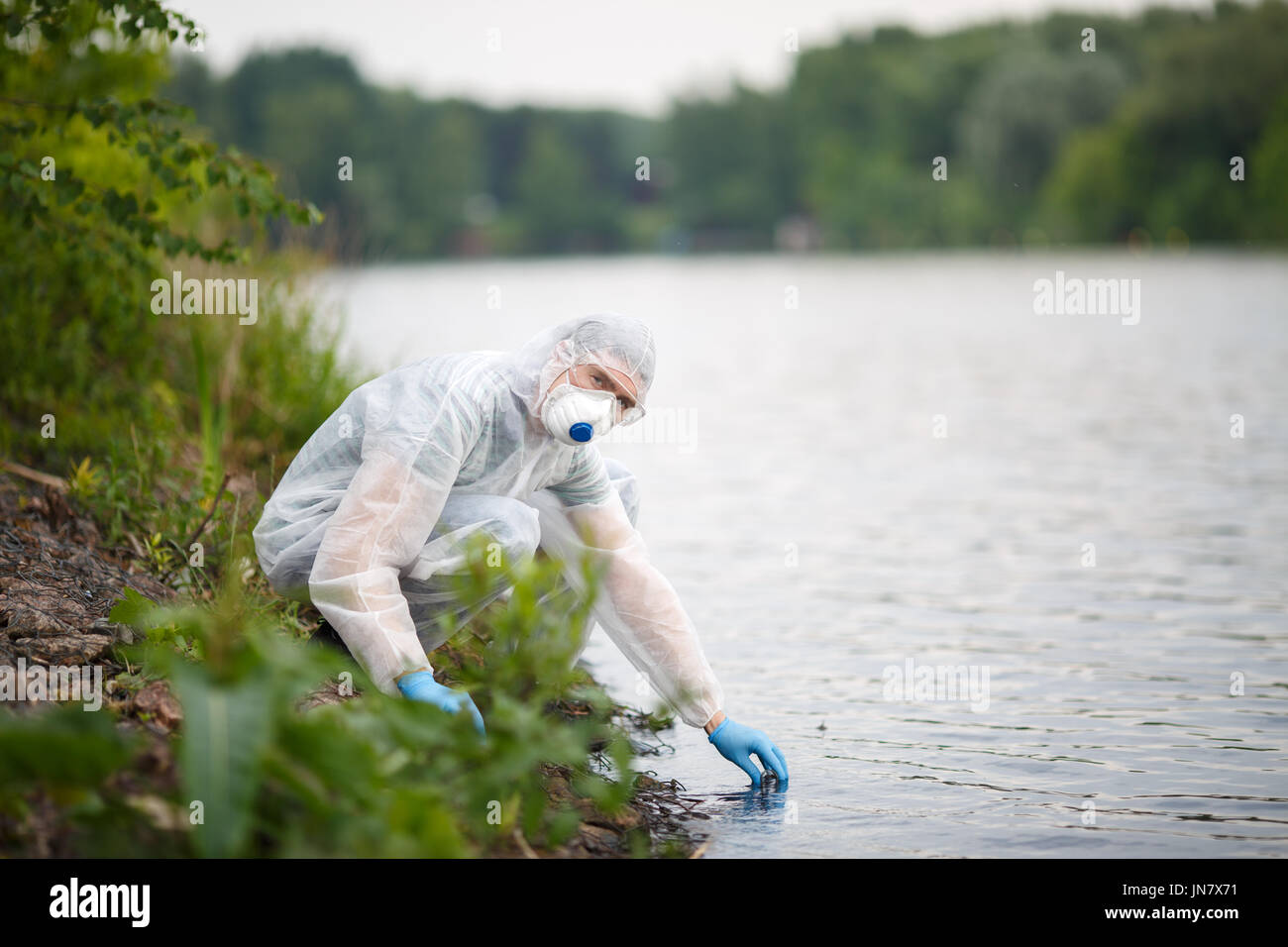 Environmentalist takes sample of water in river at summer day Stock ...