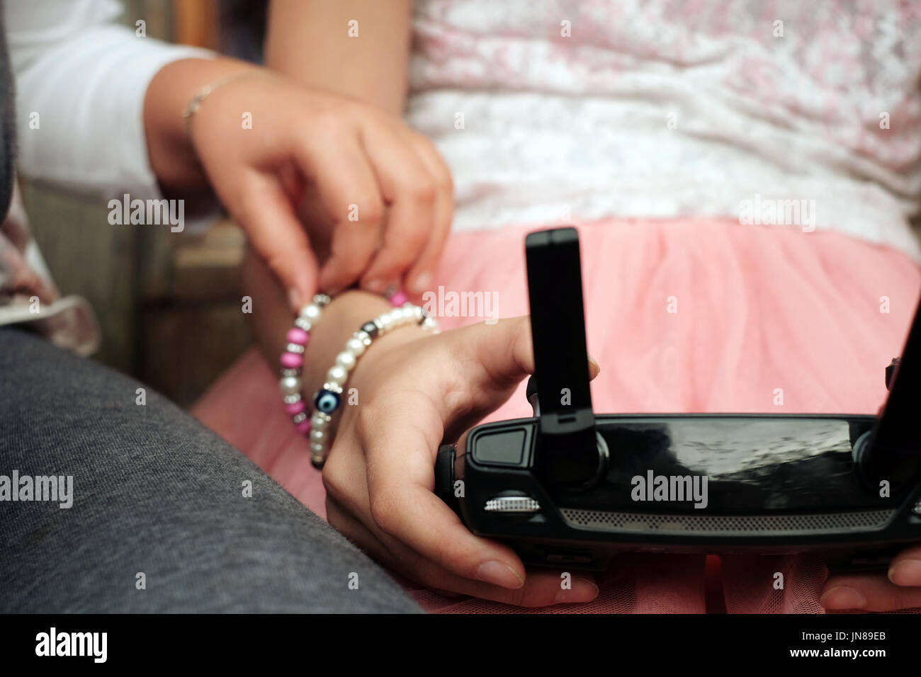 Children playing while holding a remote control in hands, closeup ...