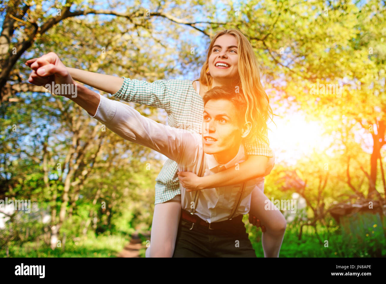 Portrait of happy couple raising their hands in open air Stock Photo ...
