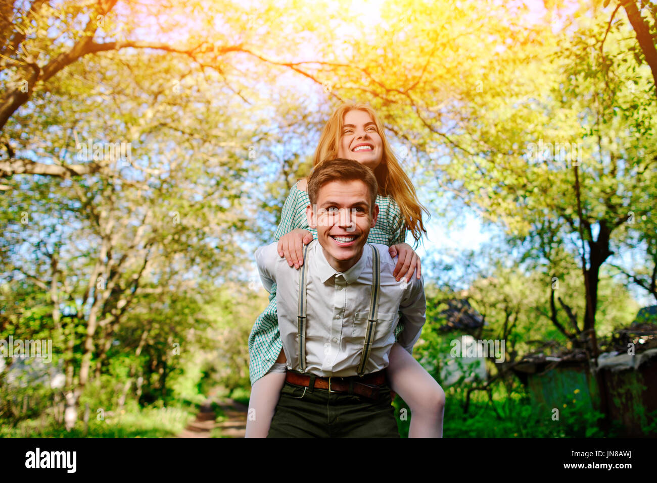 Portrait of happy couple raising their hands in open air Stock Photo ...
