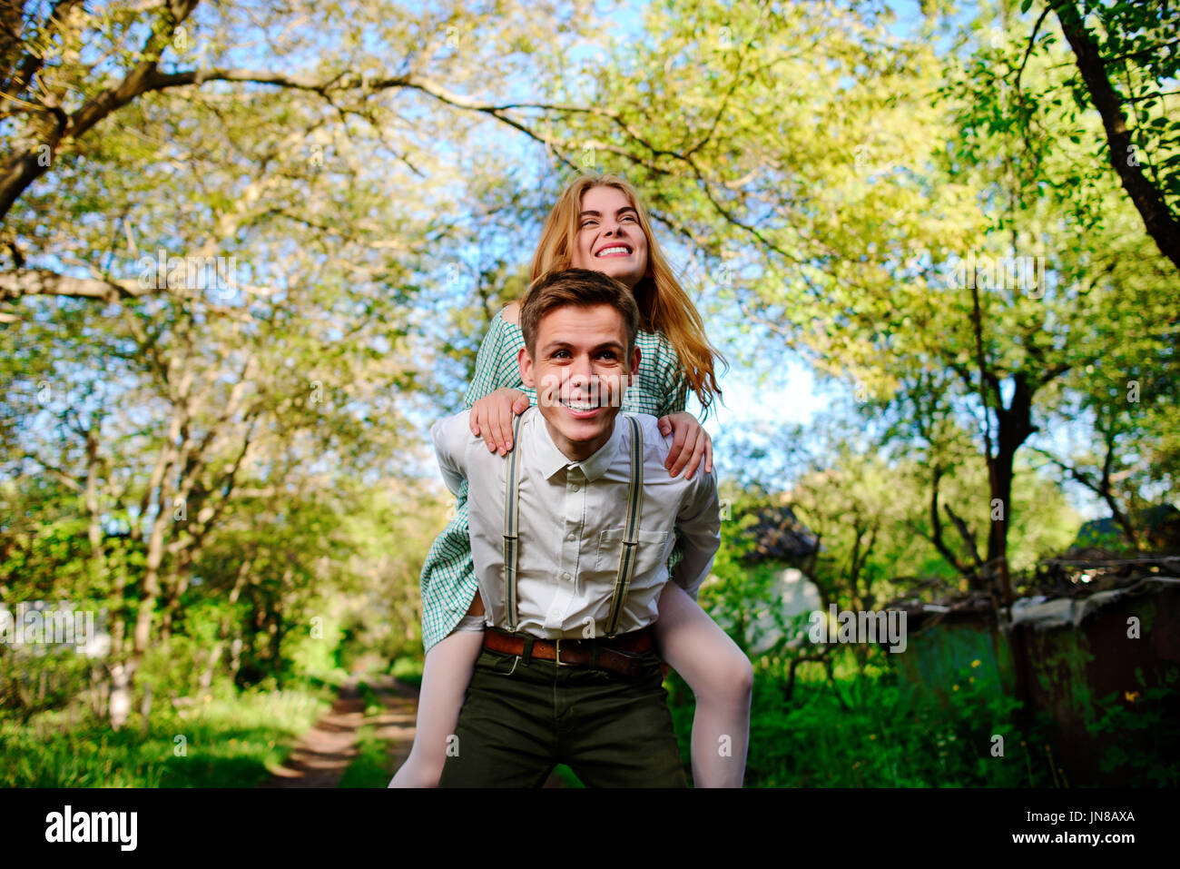Portrait of happy couple raising their hands in open air Stock Photo ...