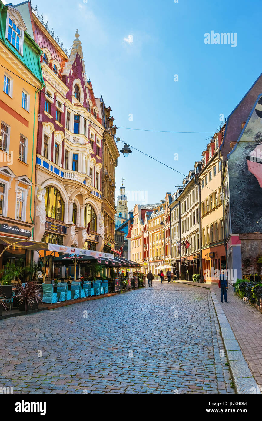 Riga, Latvia - September 3, 2014: Street with people and spire of City ...