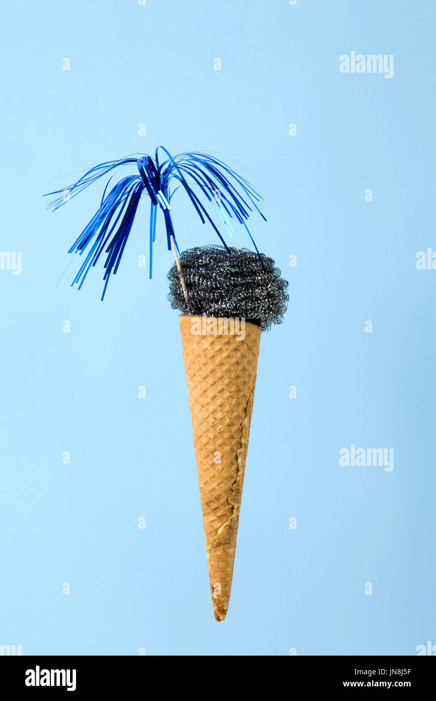 An ice cream cone whose scoop is replaced by a metallic scouring pad ...