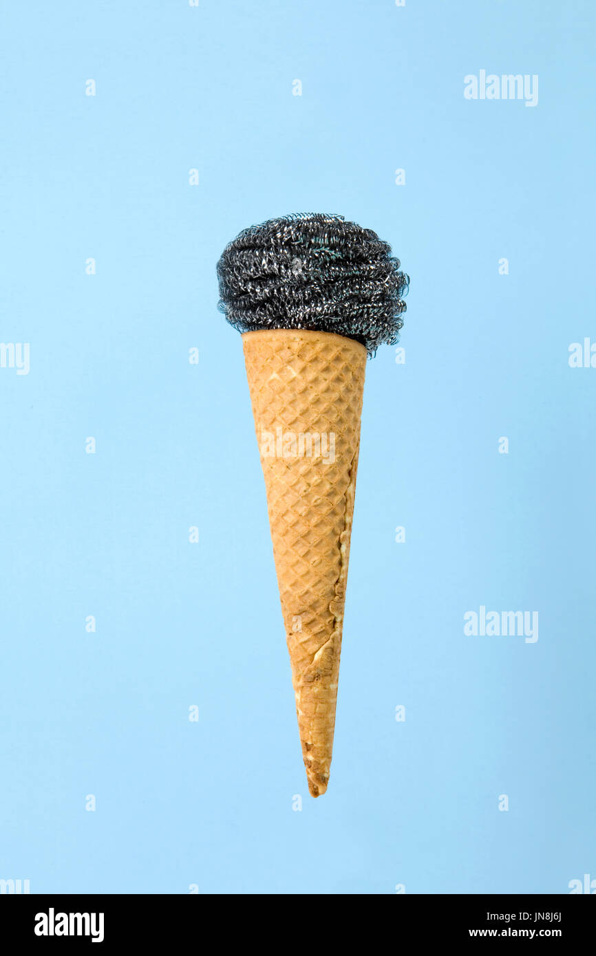 An ice cream cone whose scoop is replaced by a metallic scouring pad ...