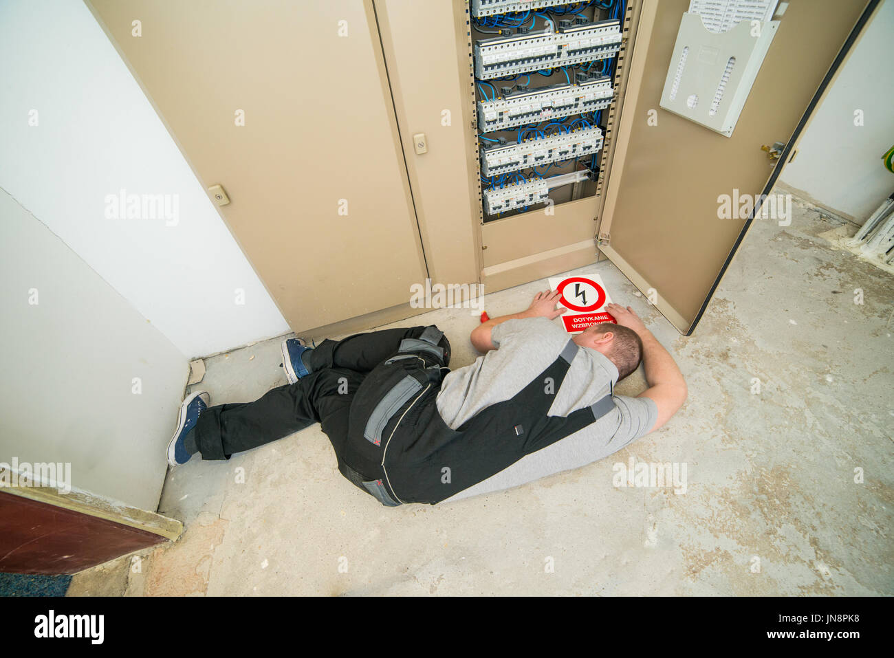 electrician electrocuted lying on the ground Stock Photo - Alamy