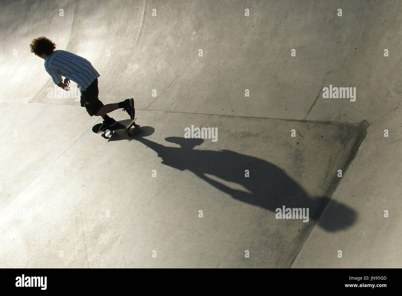 skateboarder skating the bowl at skatepark Stock Photo - Alamy