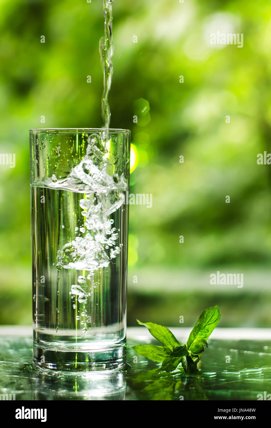 Cool fresh water with ice and mint. Splash in glass. Healthy life ...