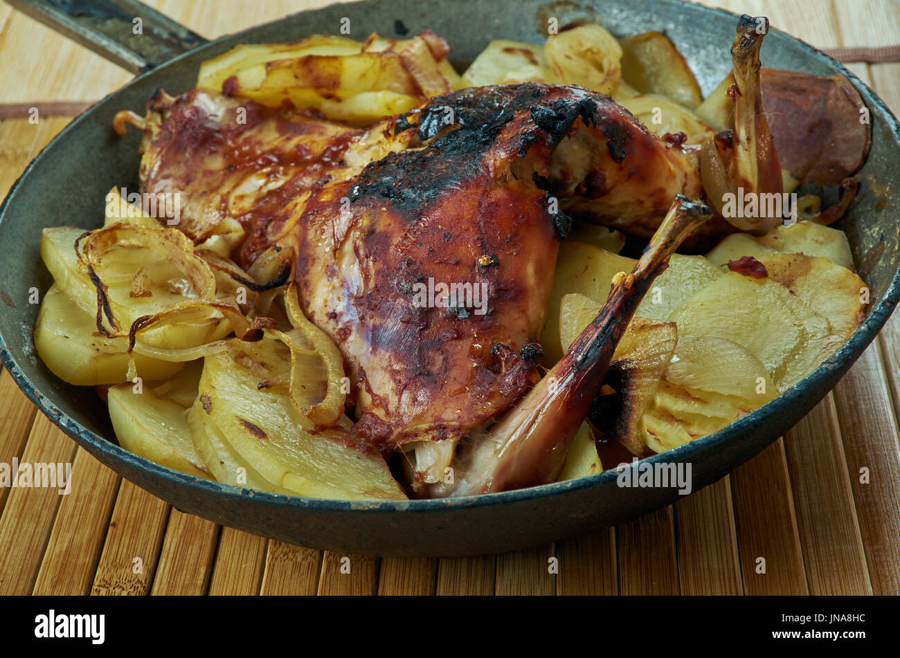 Baked rabbit with potatoes In rustic style Stock Photo - Alamy