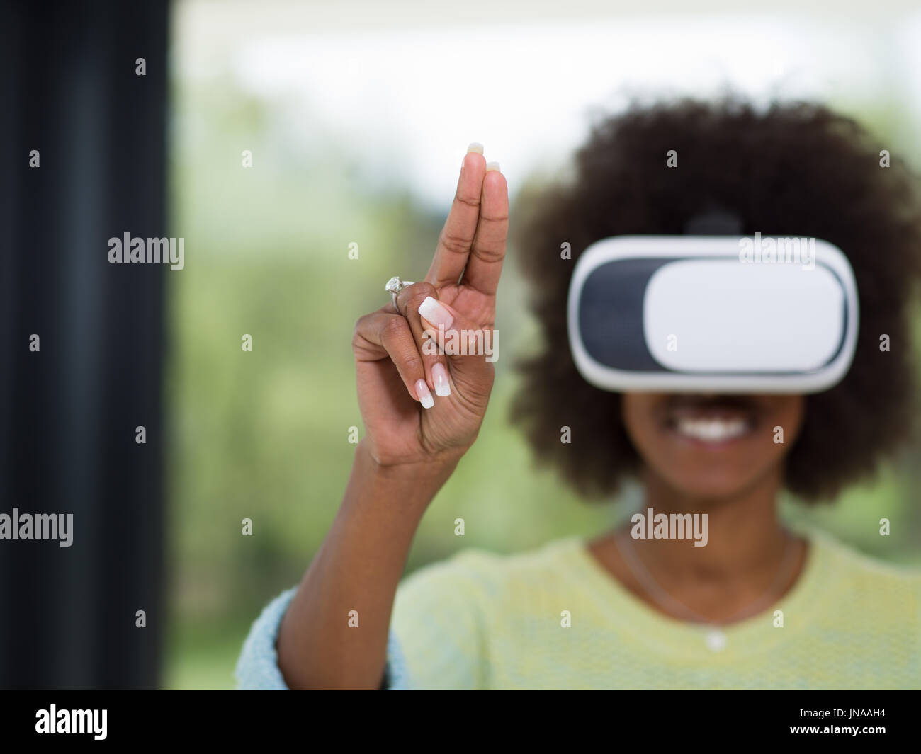 Happy african american girl getting experience using VR headset glasses ...