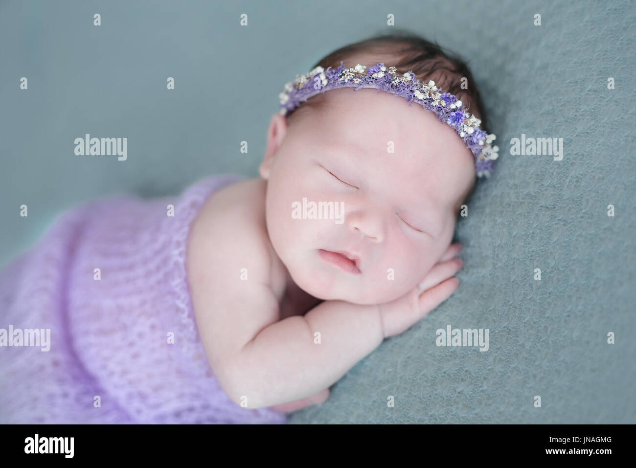 Sleeping newborn baby girl swaddled in a blanket Stock Photo - Alamy