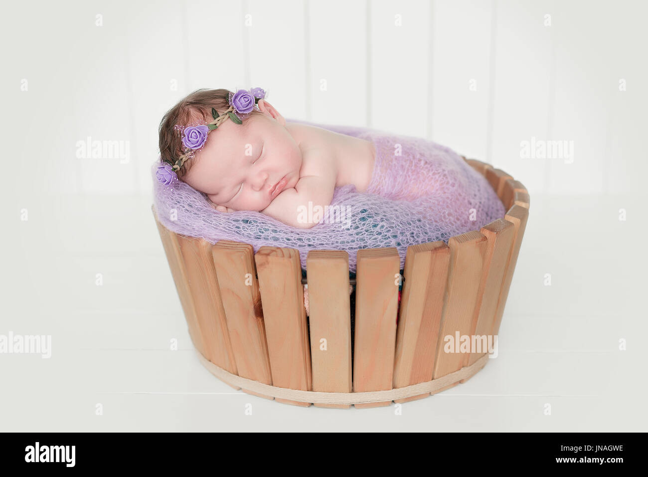 Sleeping newborn baby girl swaddled in a blanket in a basket Stock ...