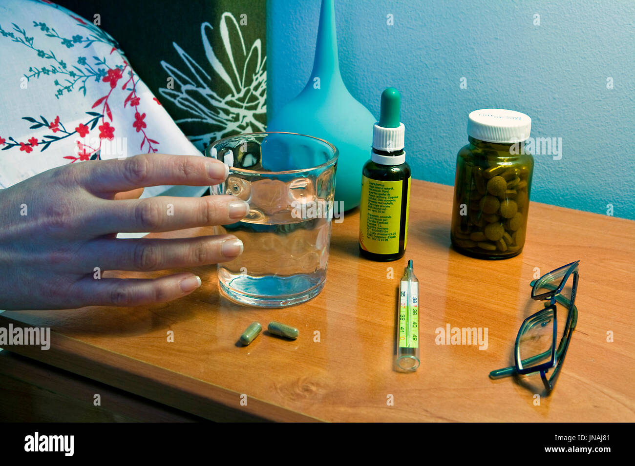 Sick Person take their medication at night Stock Photo - Alamy