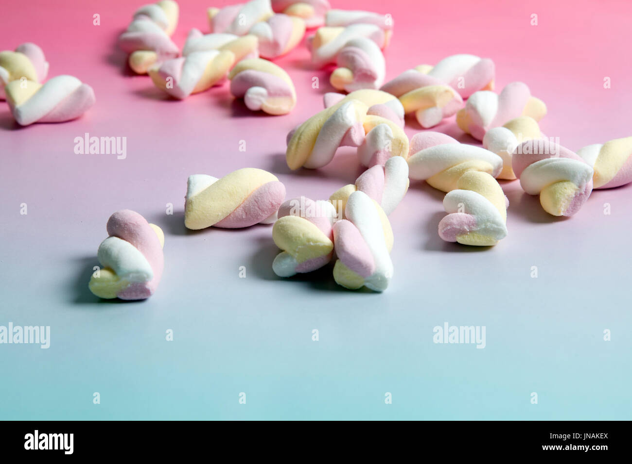 Rainbow marshmallow multi coloured candy sweets on a gradient ...