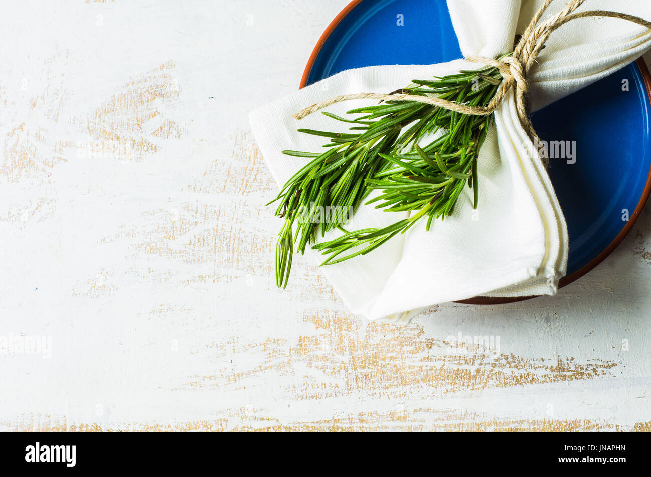 Rustic table setting with rosemary on dark wooden table with copyspace ...