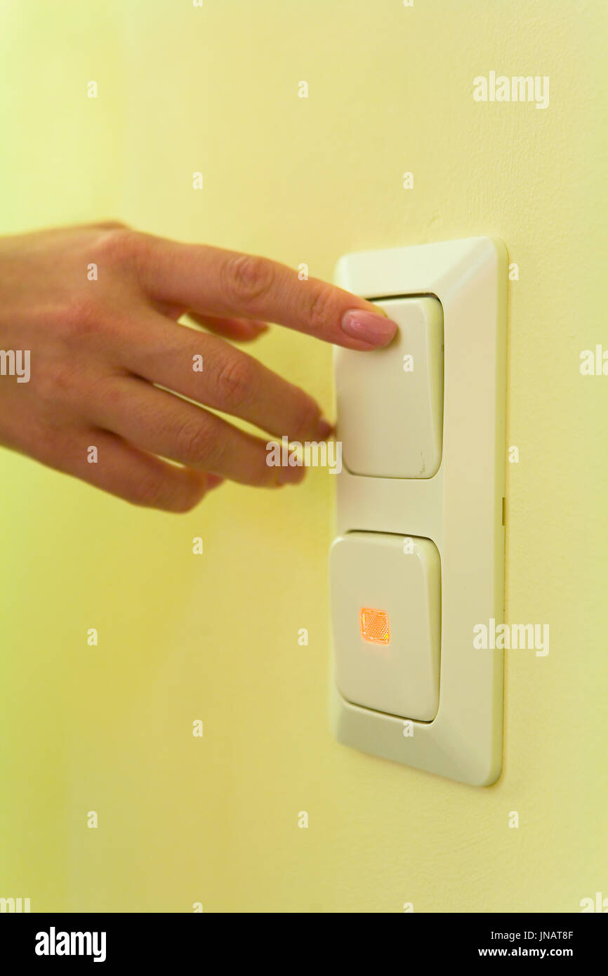 Womans hand light switch hi-res stock photography and images - Alamy