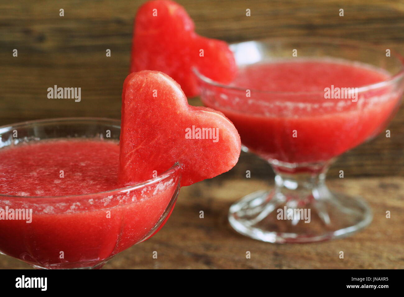 Healthy watermelon smoothie with of watermelon in heart shape on a wood ...