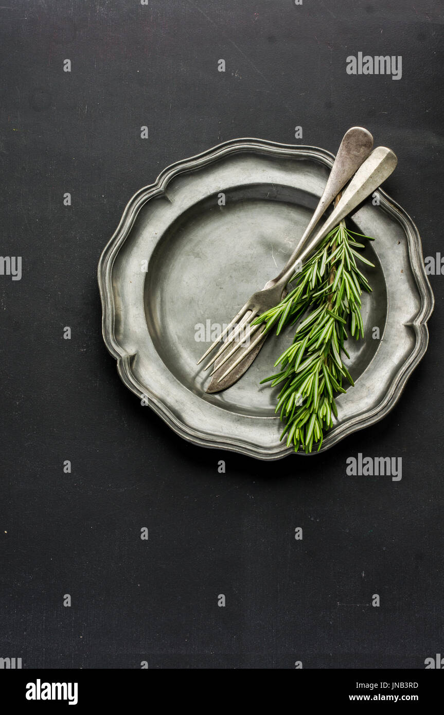 Rustic table setting with rosemary on dark wooden table with copyspace ...
