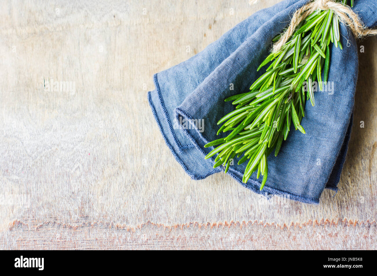 Rustic table setting with rosemary on dark wooden table with copyspace ...