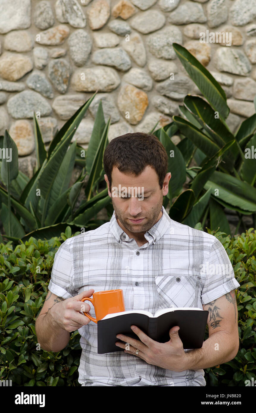 Adult male reading book hi-res stock photography and images - Alamy