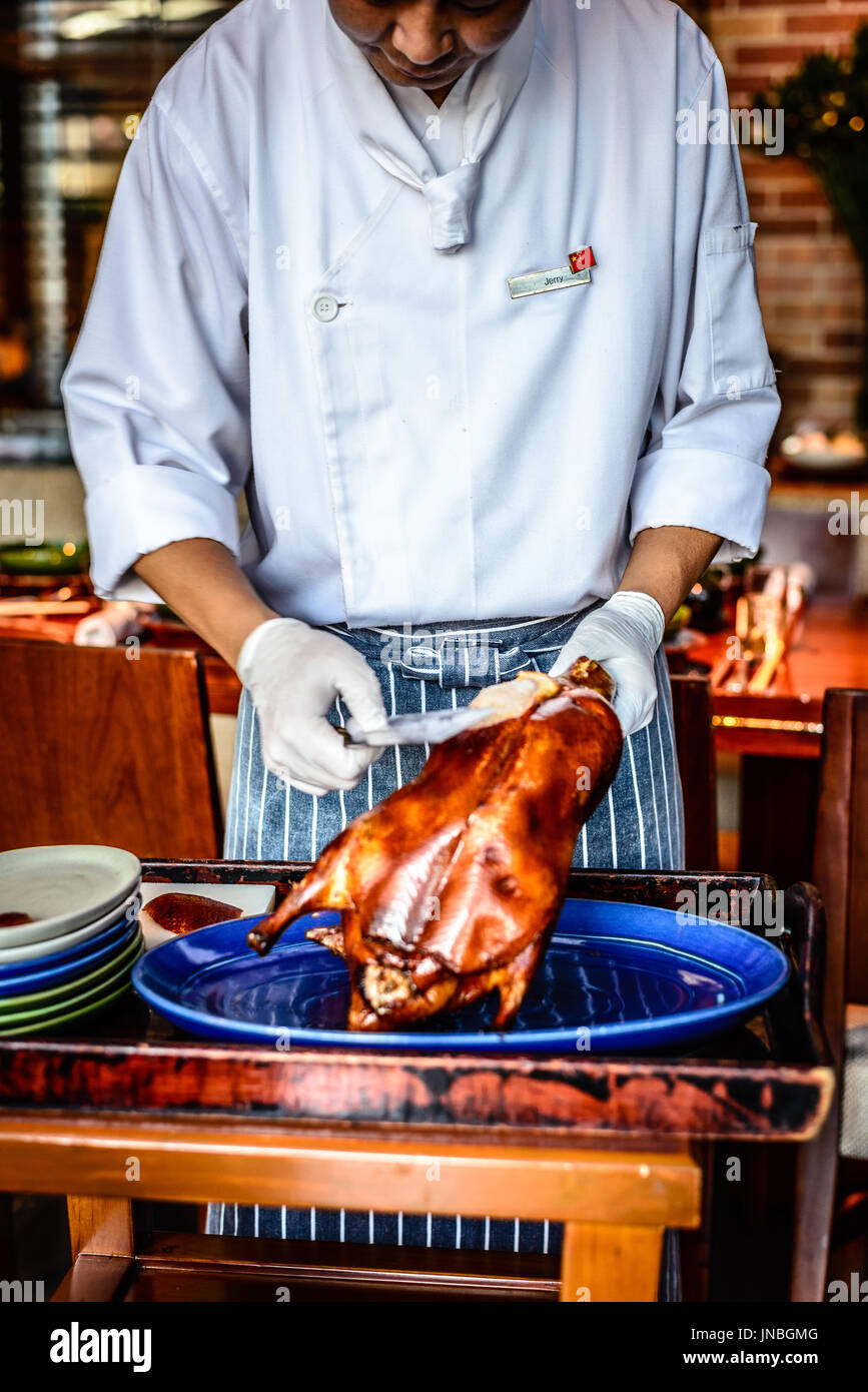 Chinese Chef chopping serving Peking duck Stock Photo - Alamy
