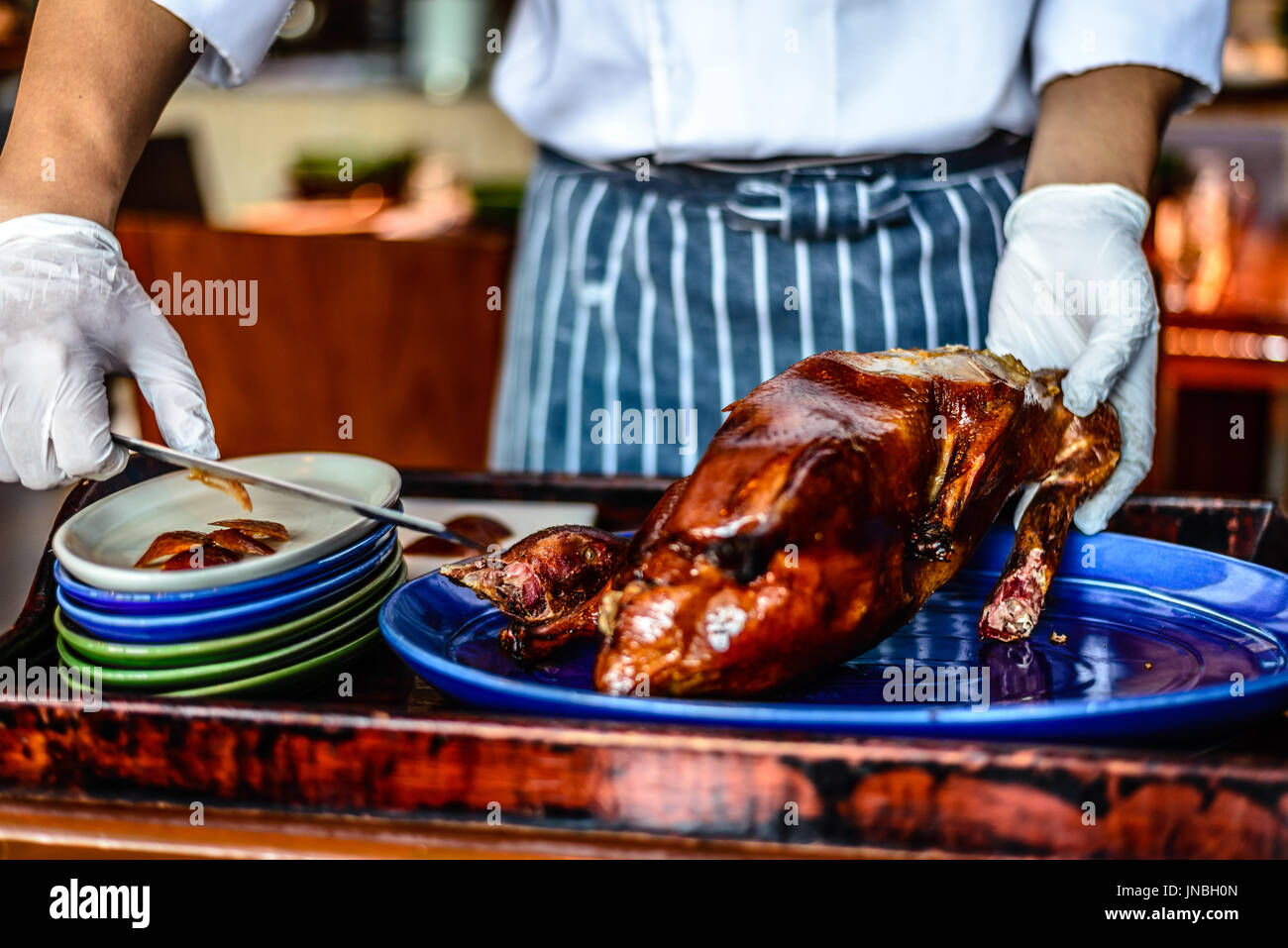 Chinese Chef chopping serving Peking duck Stock Photo - Alamy