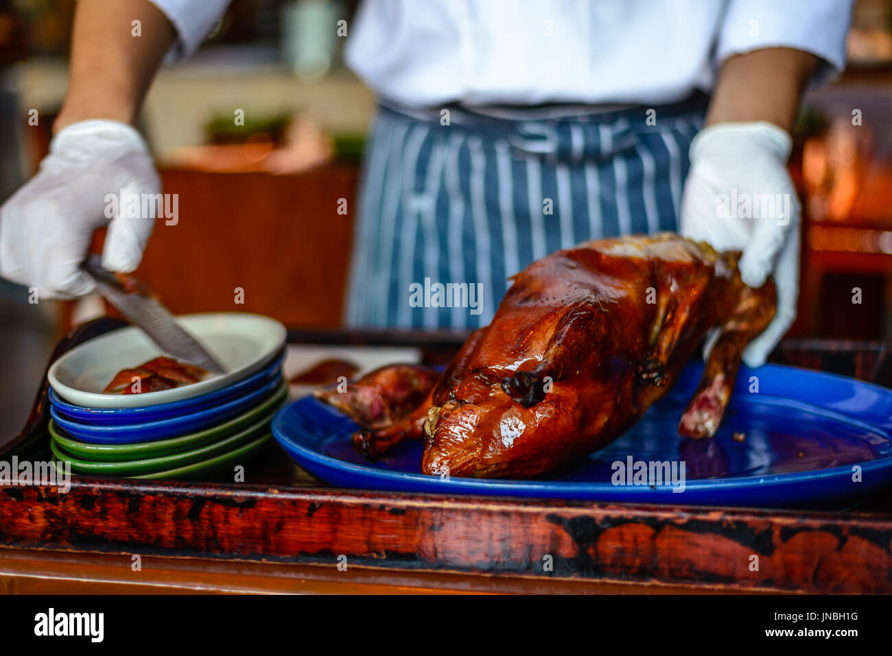 Chinese Chef chopping serving Peking duck Stock Photo - Alamy