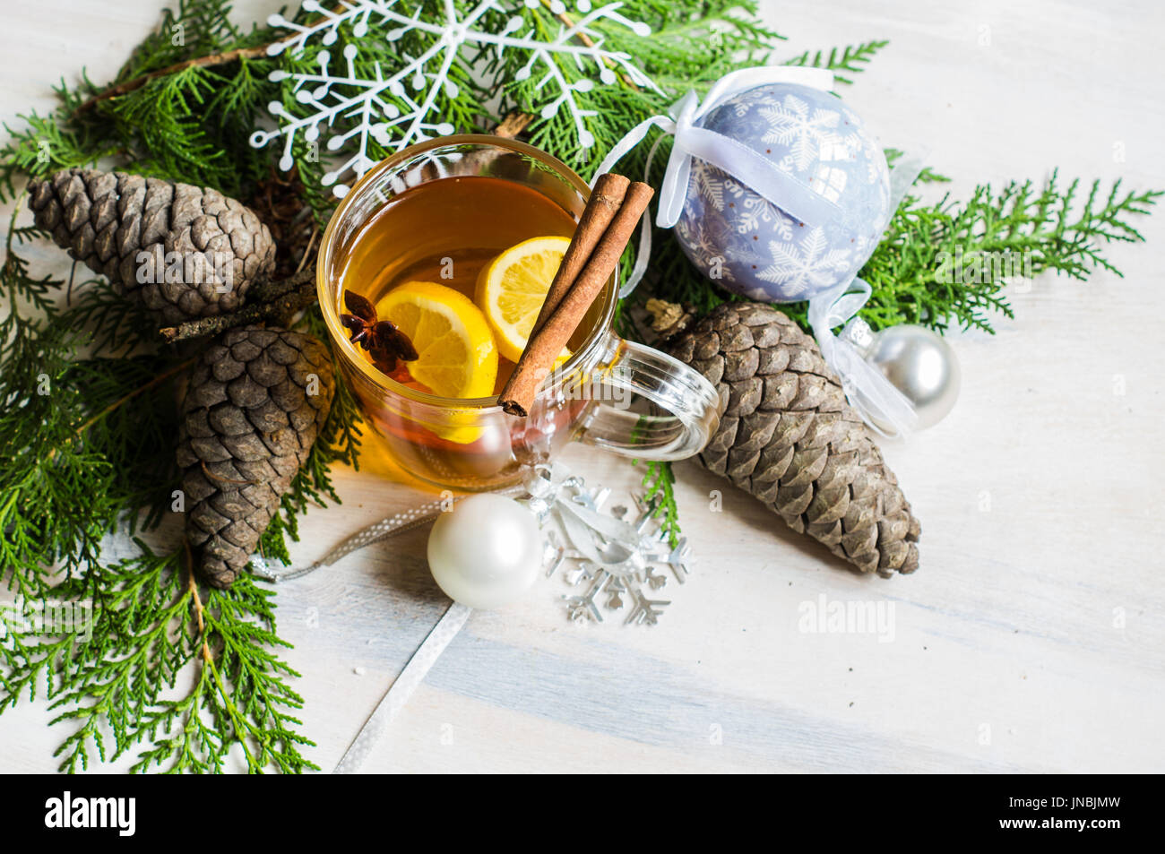 Cup of Tea with a Lemon and Cinnamon on Christmas background with snow ...