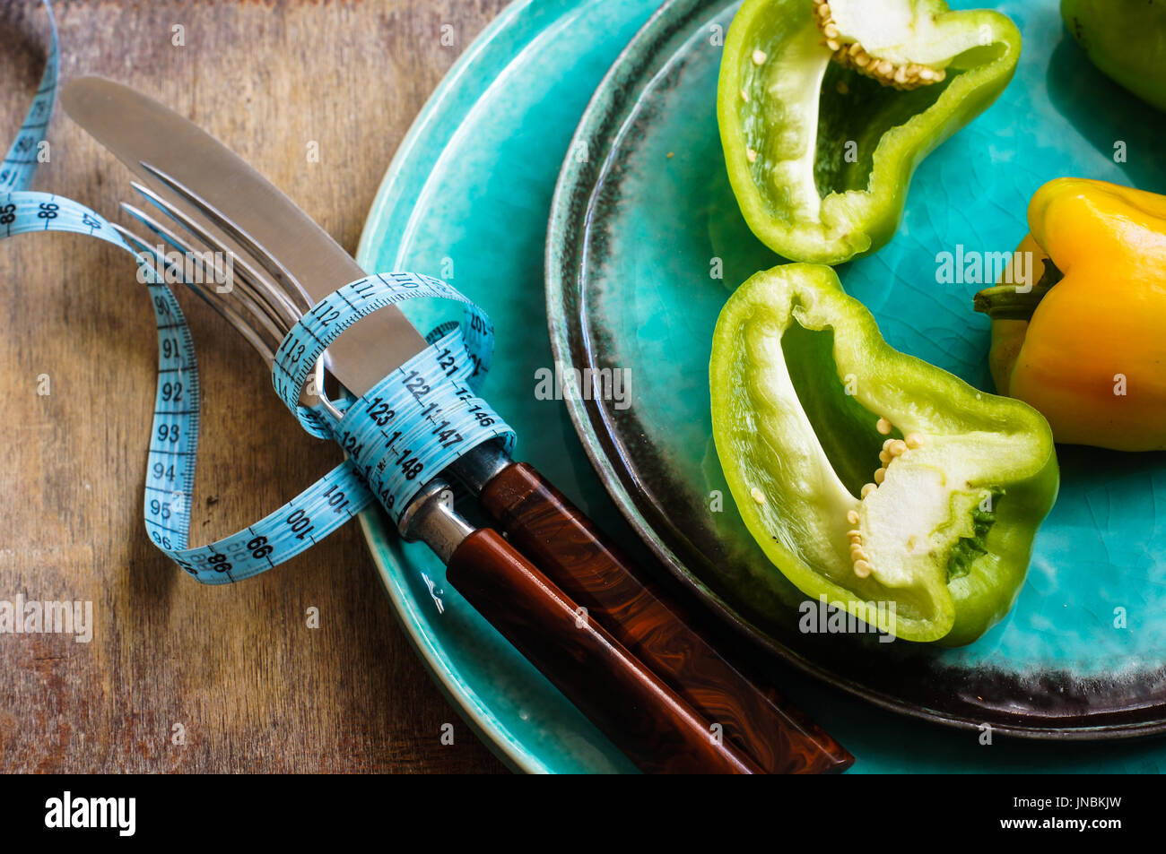 Diet concept with fresh bell pepper, silverware and measure tape Stock ...