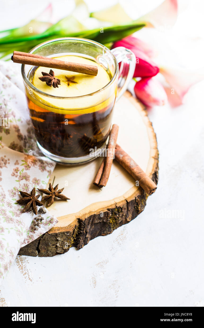 Cup of mulled tea with apple and good morning note on rustic wooden ...