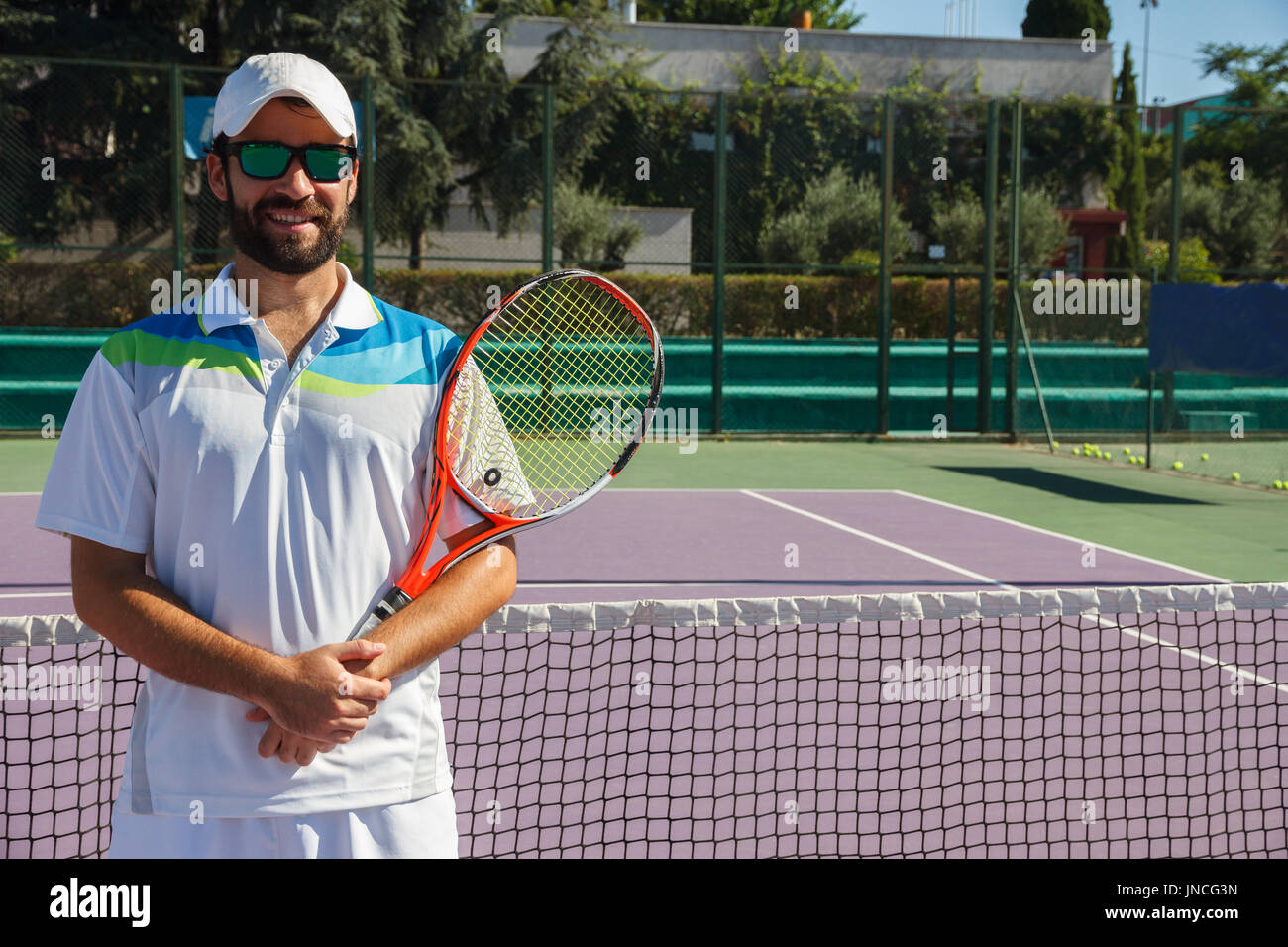 Tennis teacher welcomes you to the tennis court. He is a tennis ...