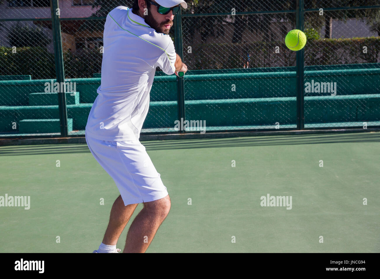 Professional tennis player playing a game of tennis on a court. He is ...