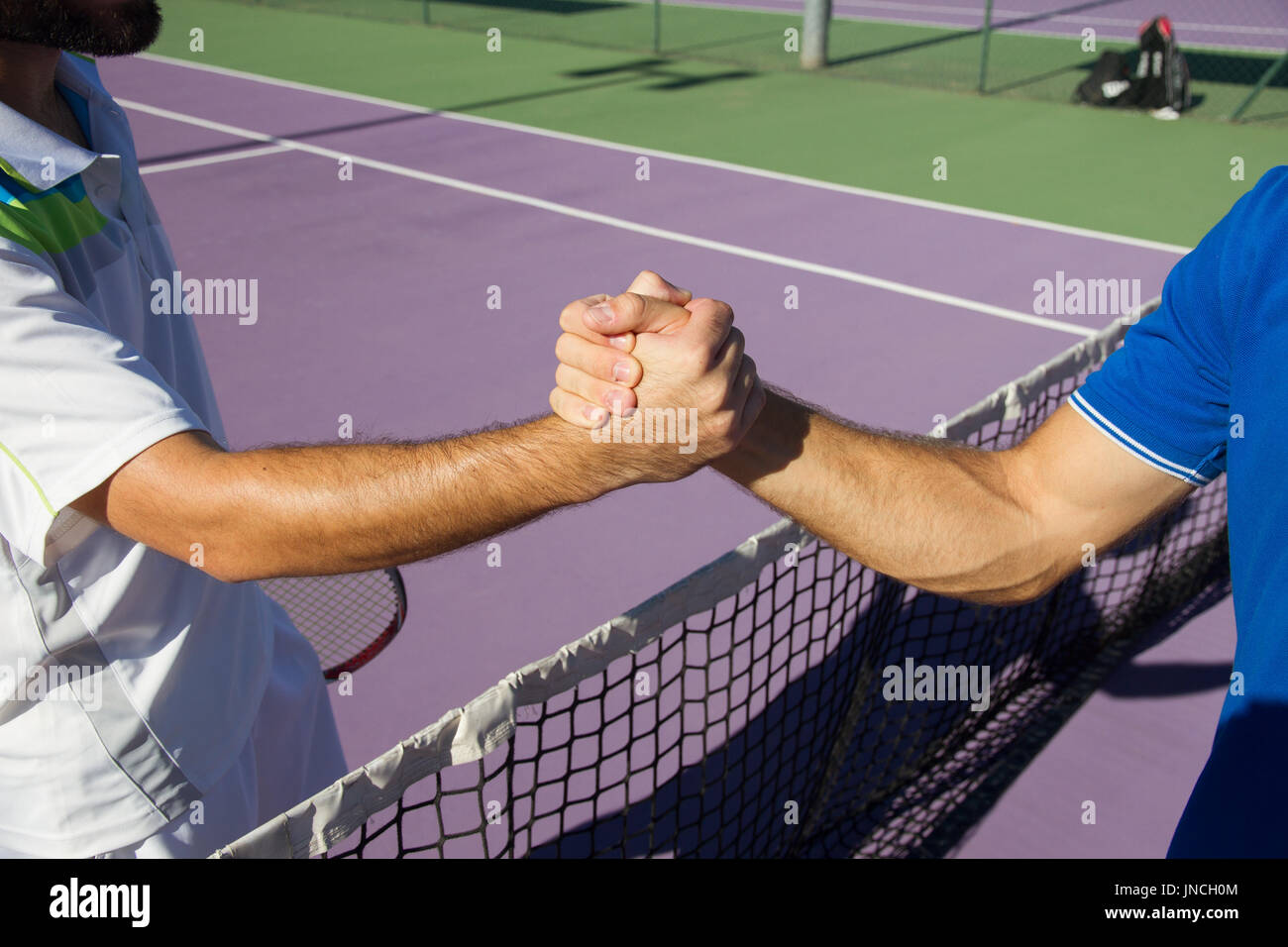 Two men, professional tennis players shake hands before and after the ...