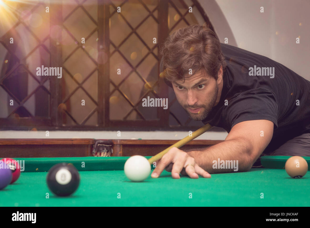 Man playing billiards in a pool table Stock Photo - Alamy