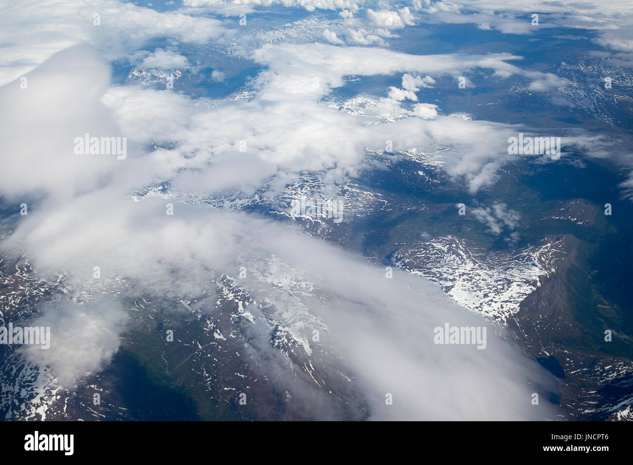 Broken cumulus cloud seen from above looking down over mountains ...