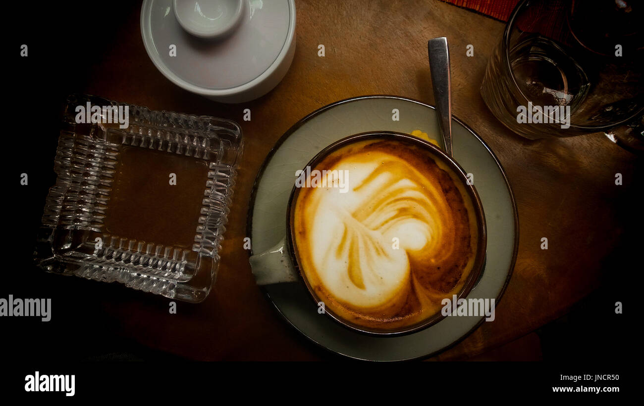 vintage theme and color of a messy table with a cup of cappuccino Stock ...