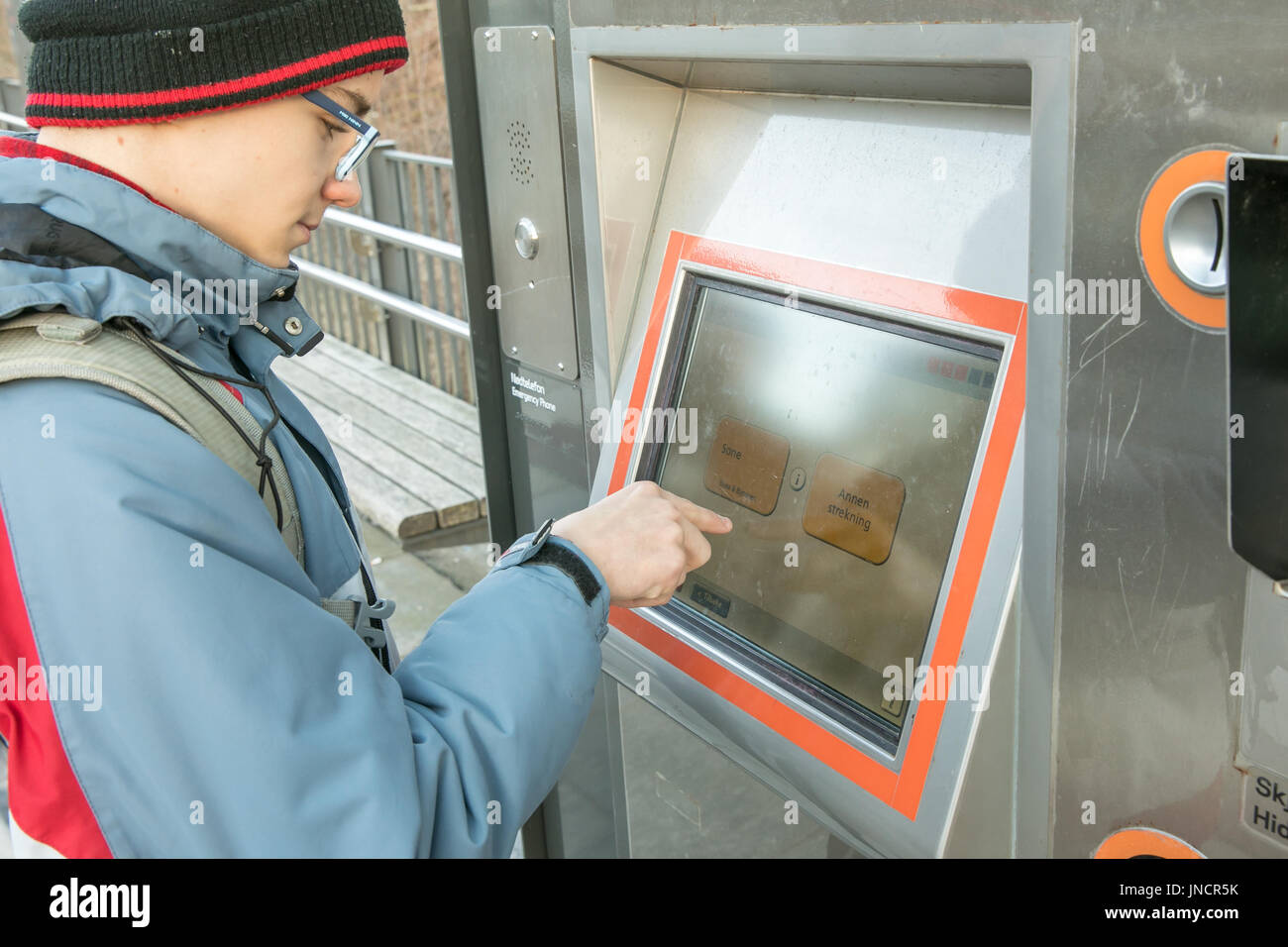 The boy buys a ticket at the color ticket booth and information point ...