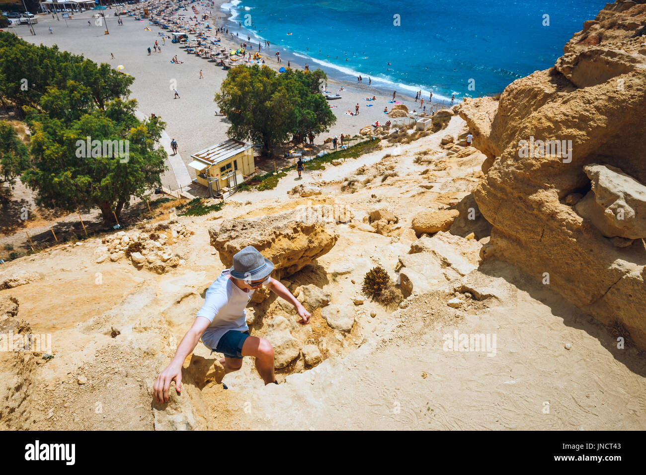 Matala beach. Caves on the rocks were used as a roman cemetery and at ...
