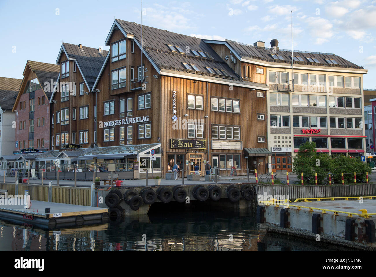 Historic wooden buildings bars and restaurants along harbour waterside ...
