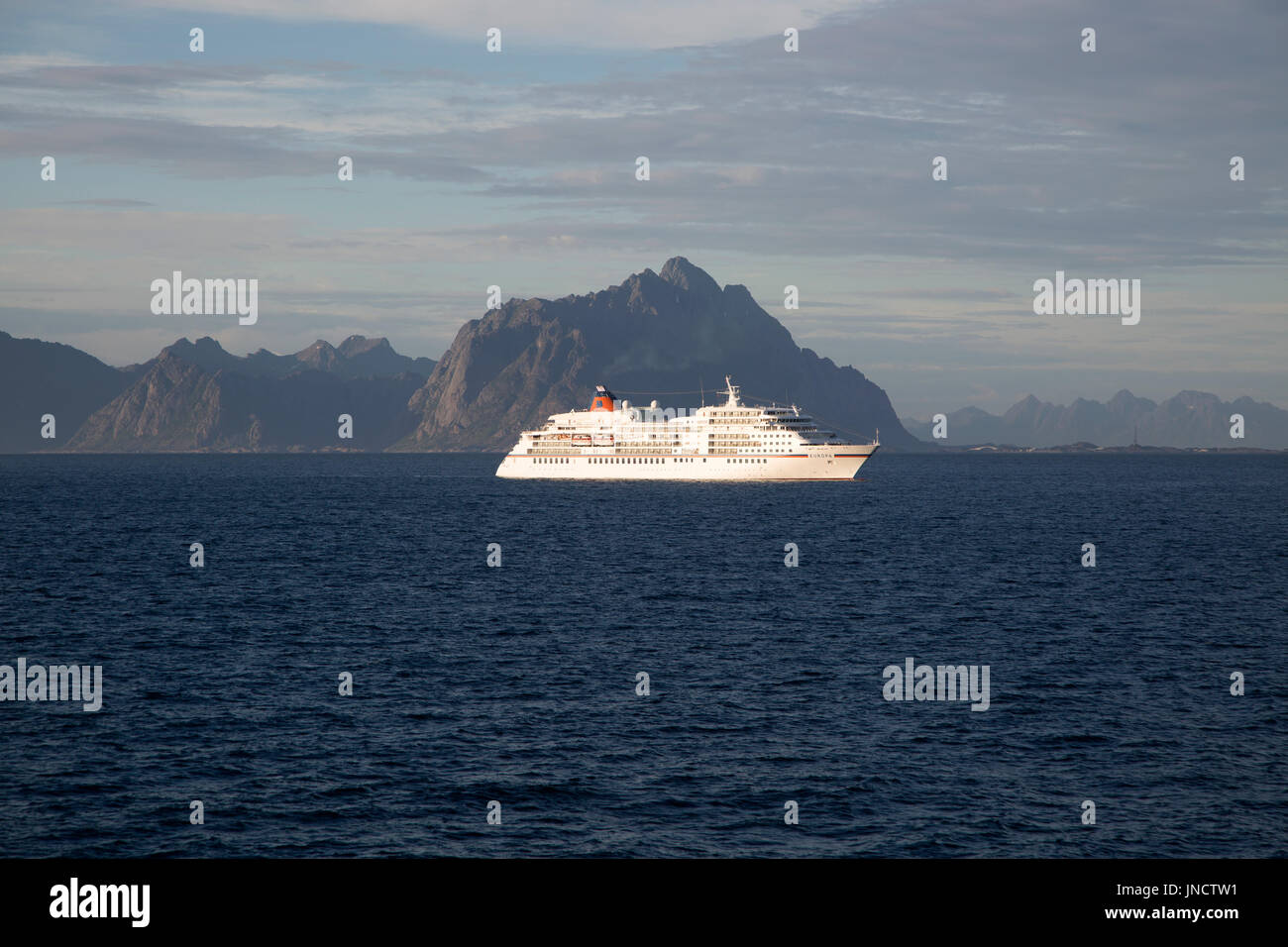 Cruise ship passing mountains of Lofoten Islands, Nordland, Norway ...
