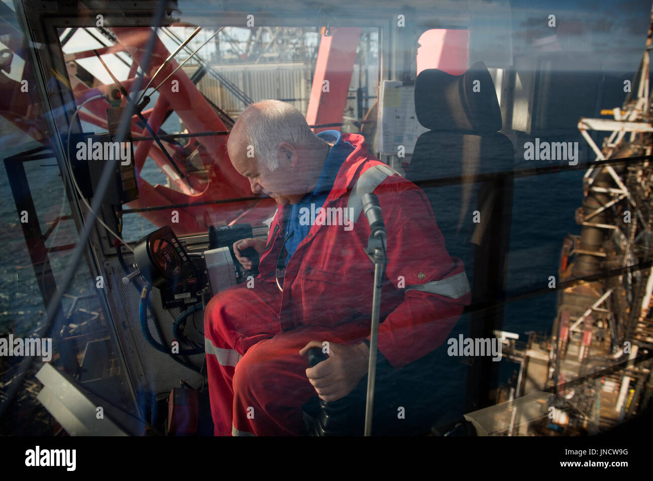 A crane operator (driver) working his crane while offloading containers ...