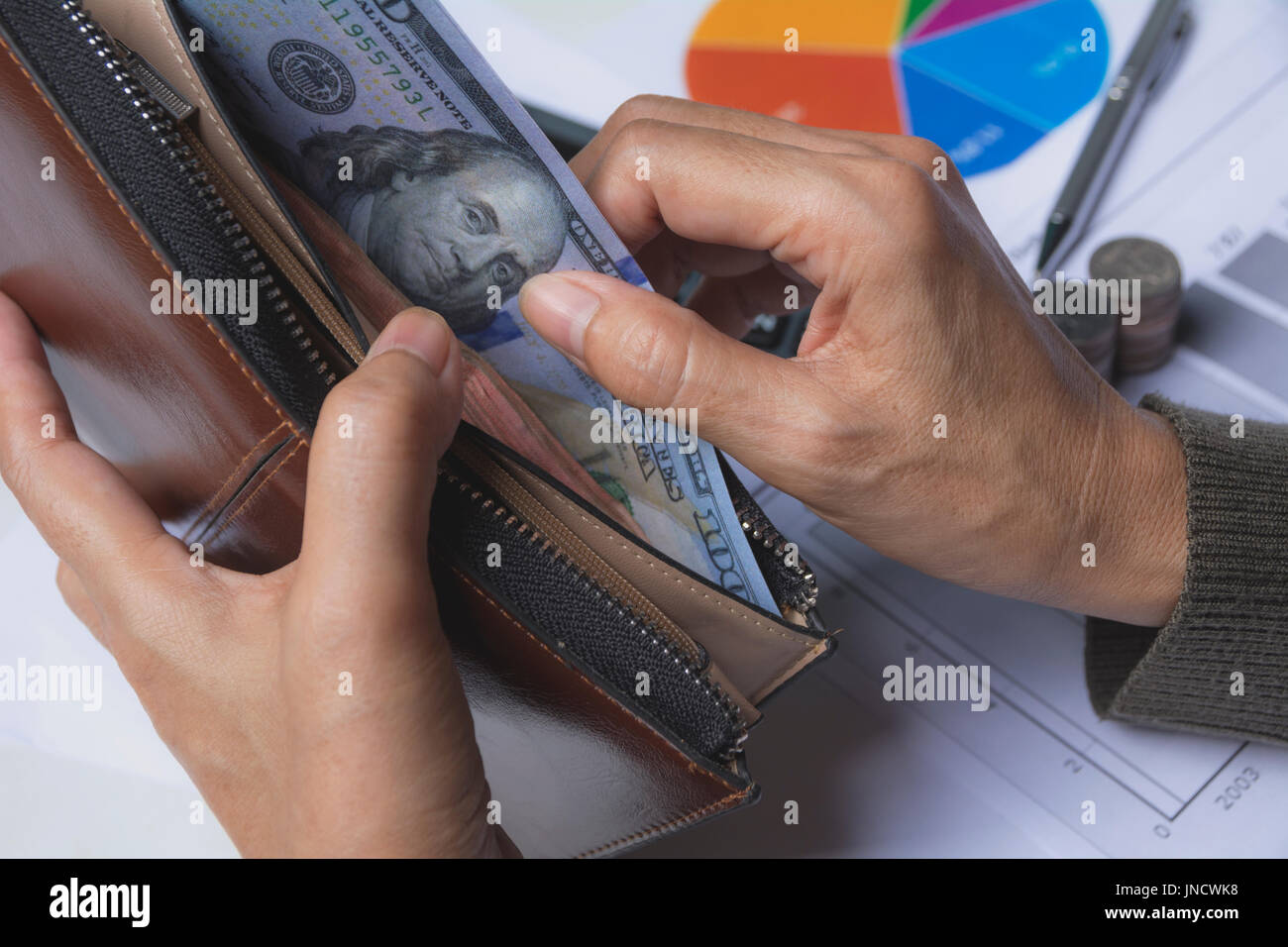 Businessman holding banknote in wallet in his hand for financial and ...