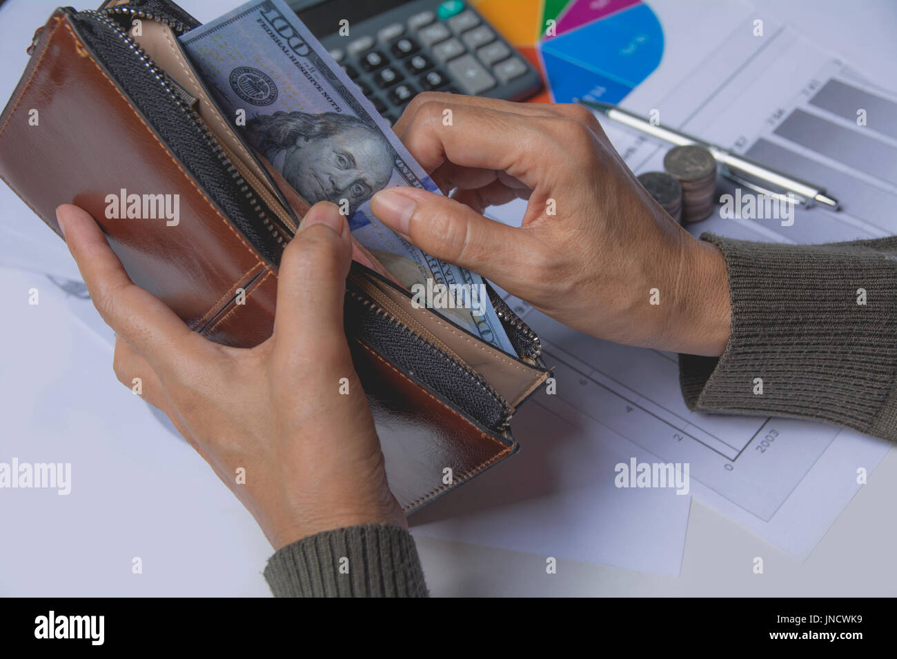 Businessman holding banknote in wallet in his hand for financial and ...