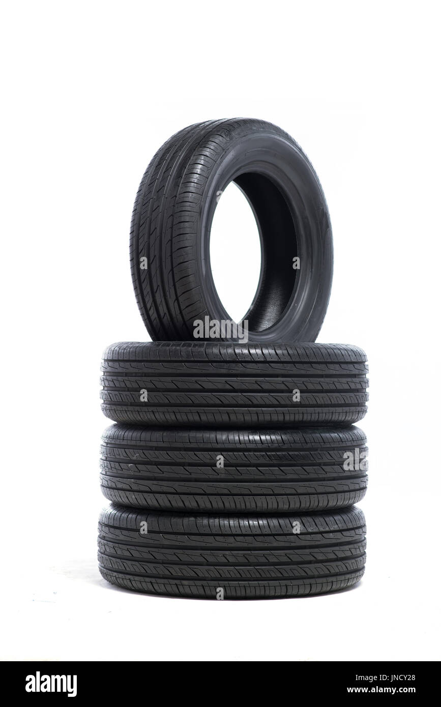 Pile of unused car tires isolated on white background. Tyre service or ...